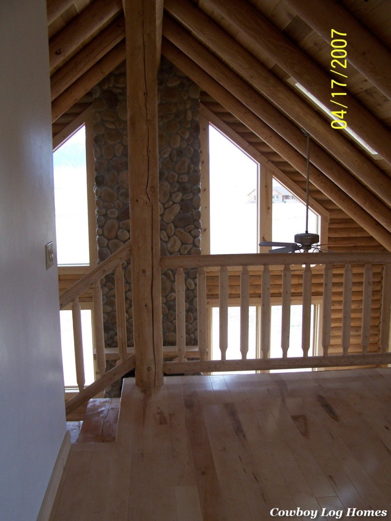 Log Home with Round Log Support Posts and Log Rafters | Cowboy Log Homes